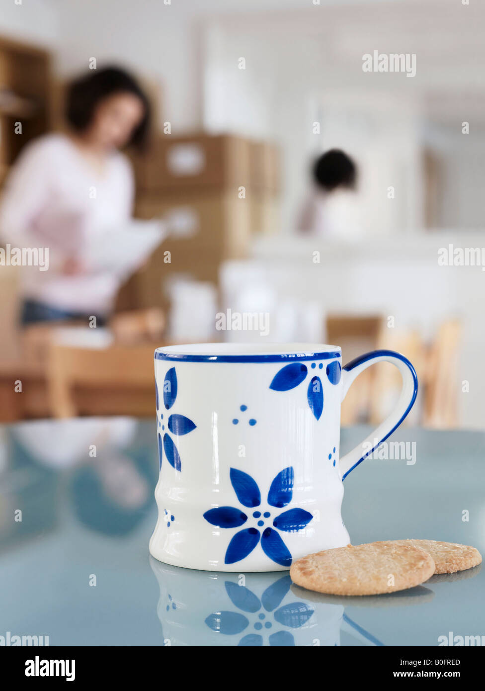 Cup and biscuits on office table Stock Photo - Alamy