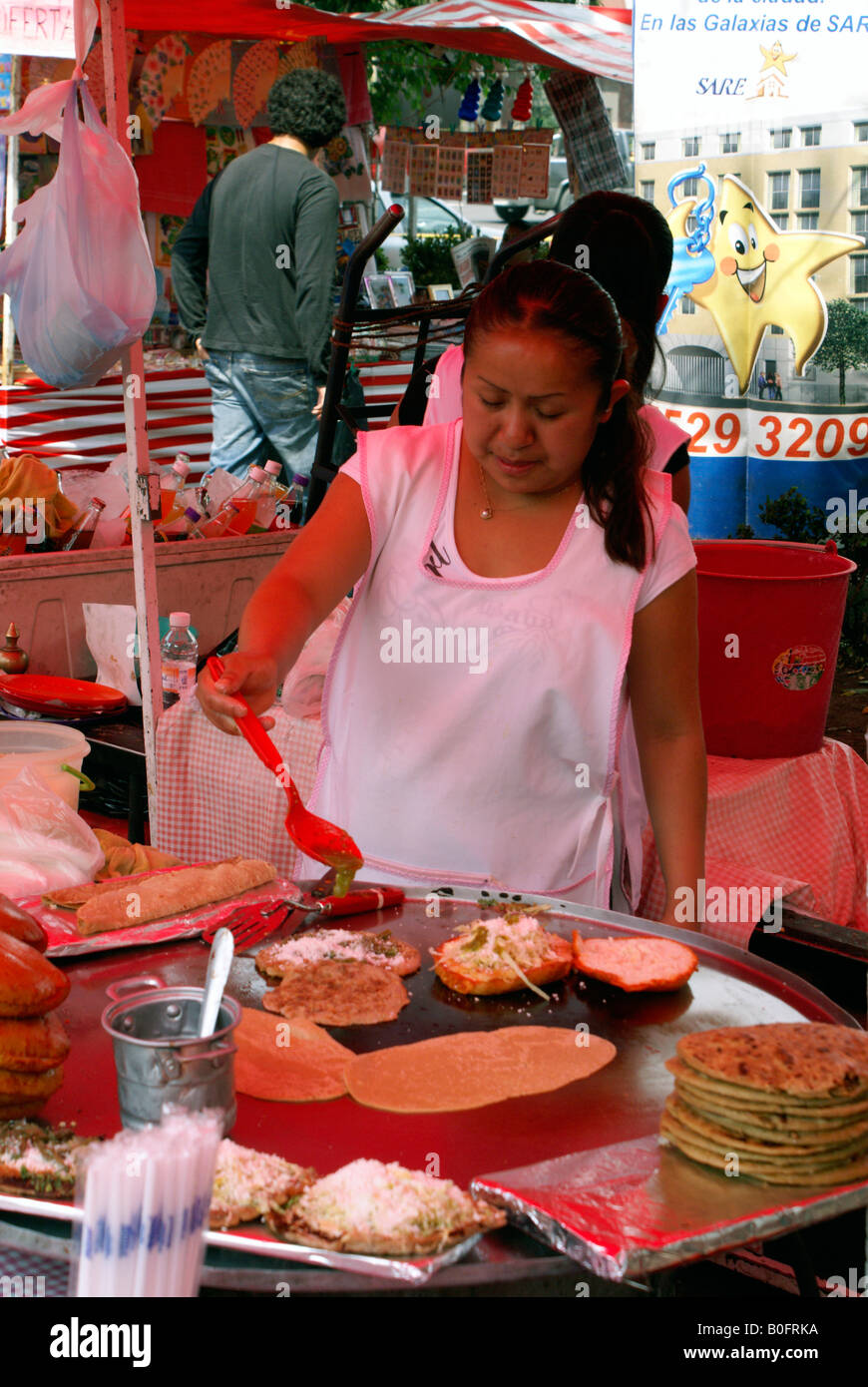 Woman cooking Mexican food at a sidewalk food stall in Mexico City ...