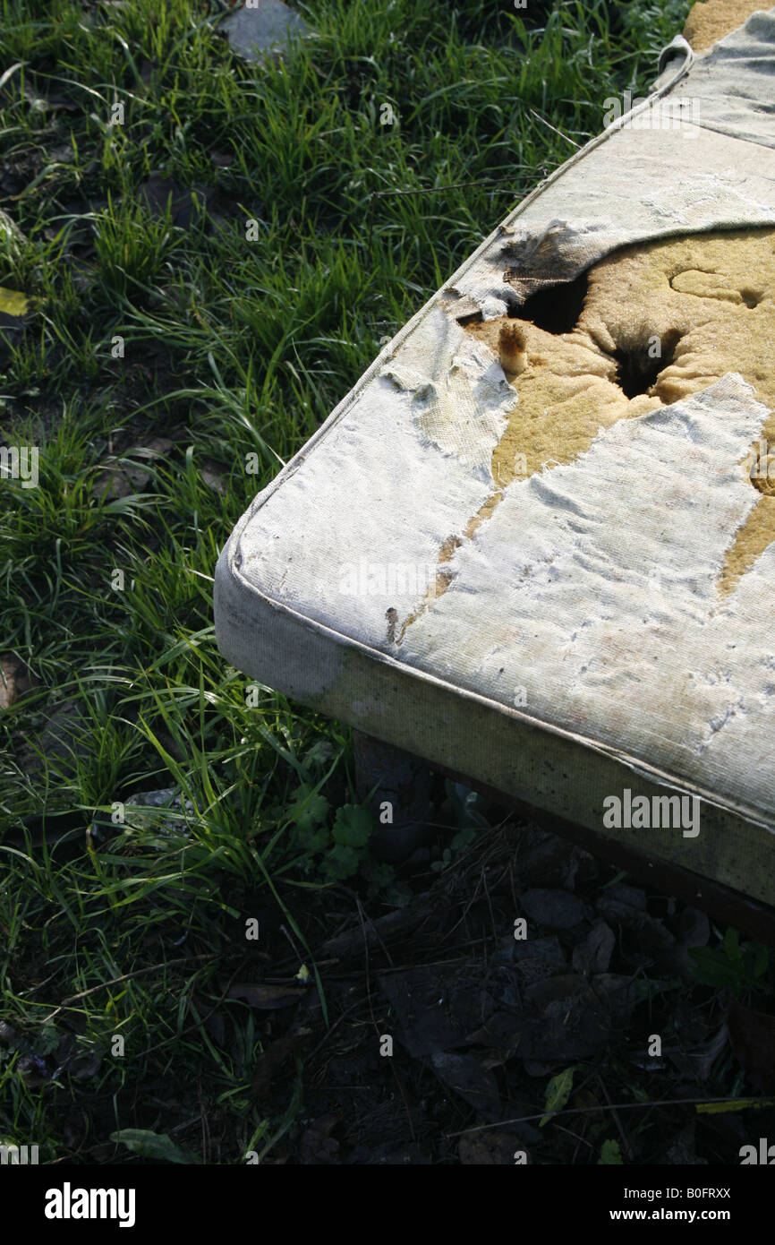 old mattress abandoned with hole Stock Photo - Alamy