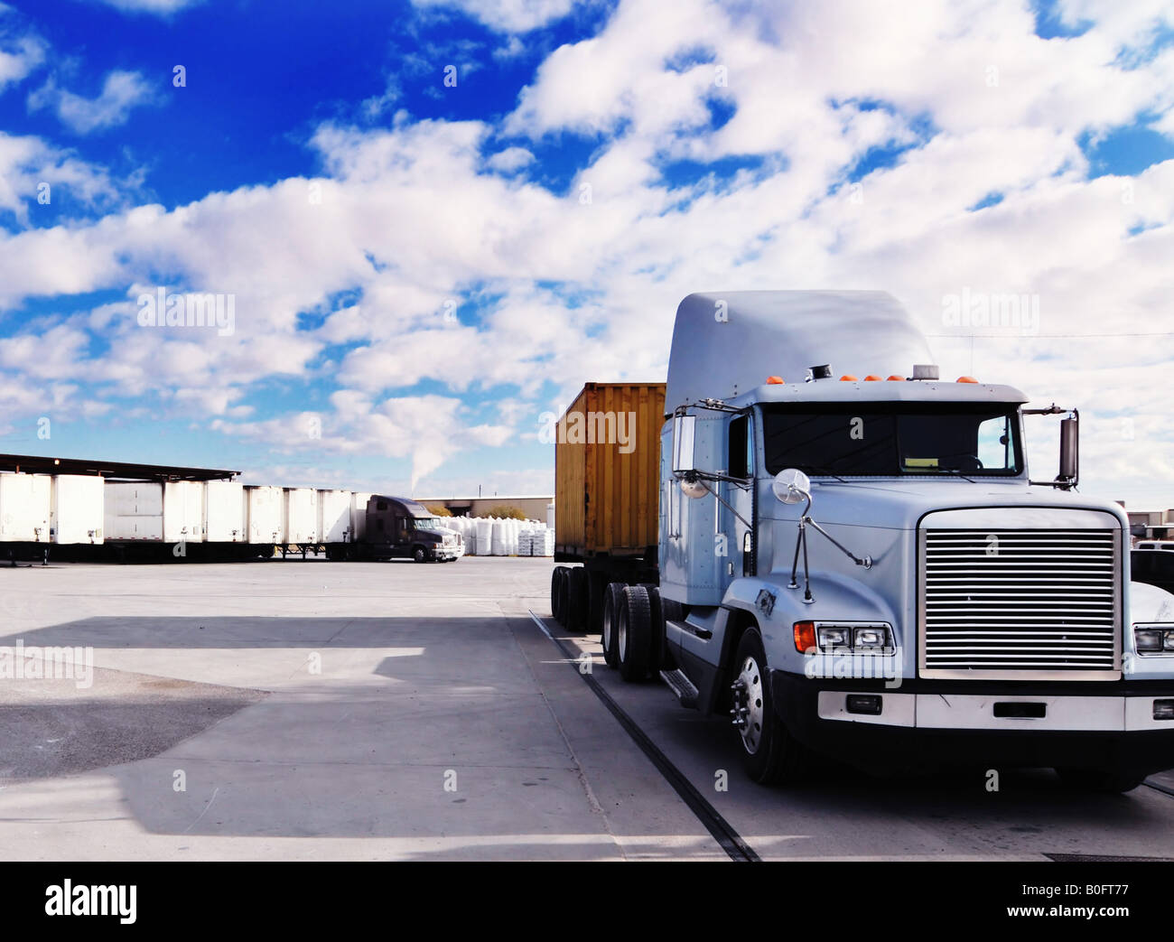 Heavy goods truck leaving loading bay Stock Photo - Alamy
