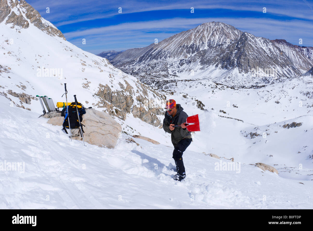 Backcountry skier checking snow conditions under Mount Abbott Inyo ...