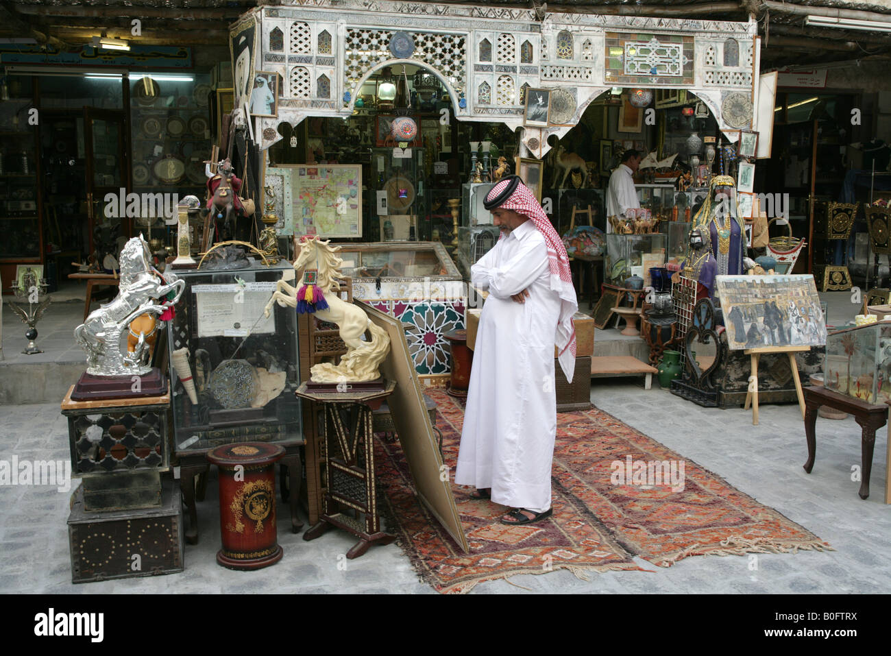 Qatari customer browsing antique market stall in Souq Waqif, Doha ...