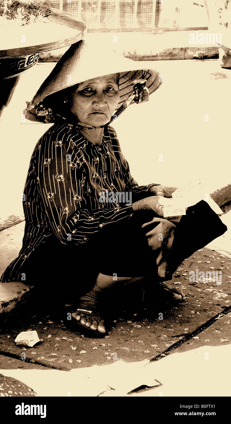 welcome to saigon, old lady, cigarette seller, counting her daily ...