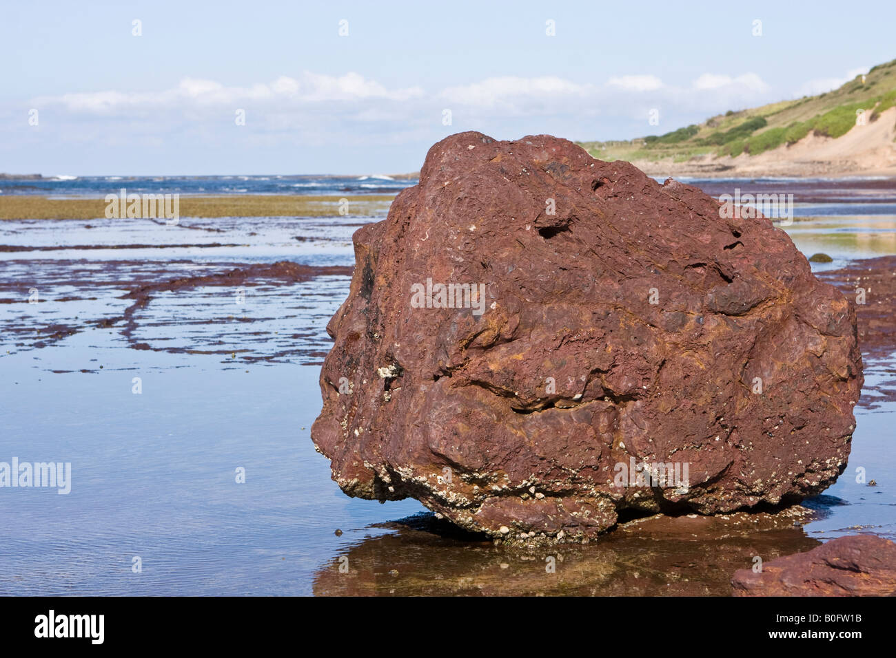 A boulder from the cliff behind laying in a rock pool Stock Photo - Alamy