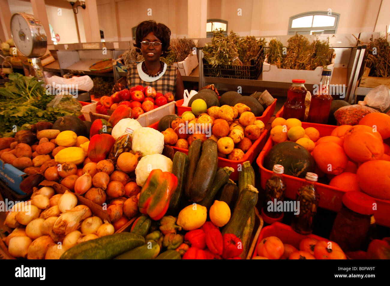 woman selling fruit and vegetables in the market hall in Mindelo Sao ...