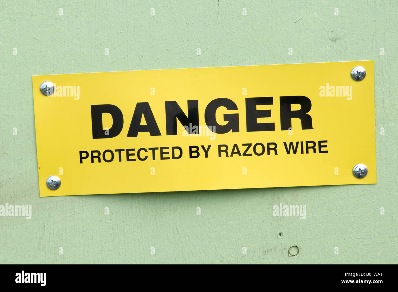 Danger Protected by Razor Wire warning sign to building site Stock ...
