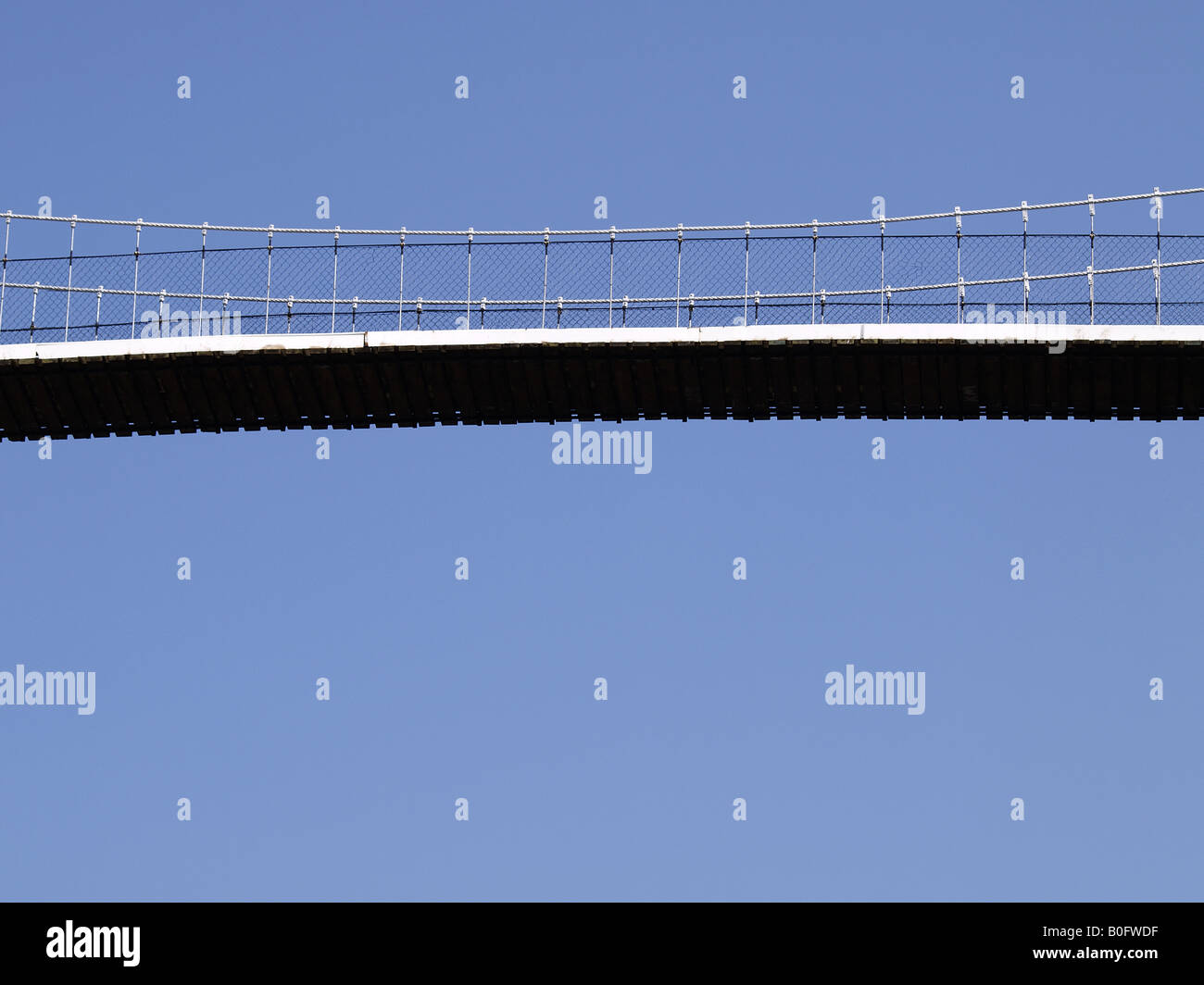 Suspension footbridge backed by a clear blue sky Stock Photo - Alamy