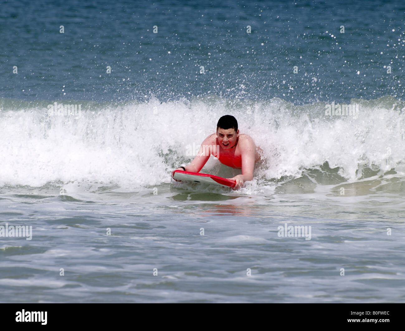 Teenager having fun in the waves with a bodyboard Newquay, Cornwall, UK ...