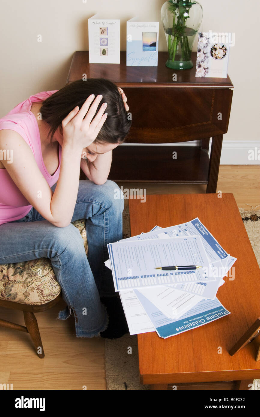 Distressed young widowed woman trying to filli out probate and ...