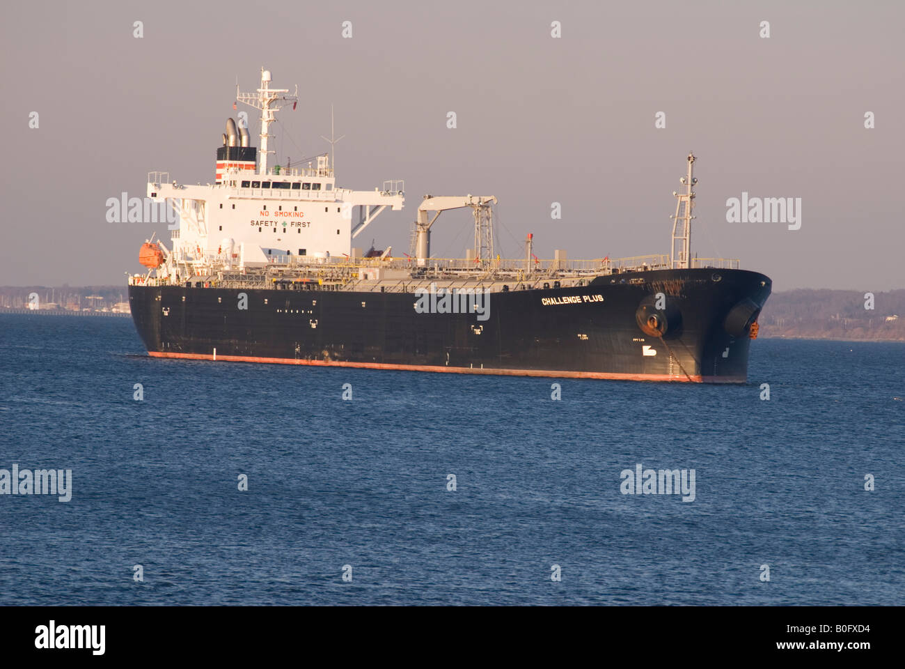 A merchant vessel anchored in the ocean water between Jamestown and ...