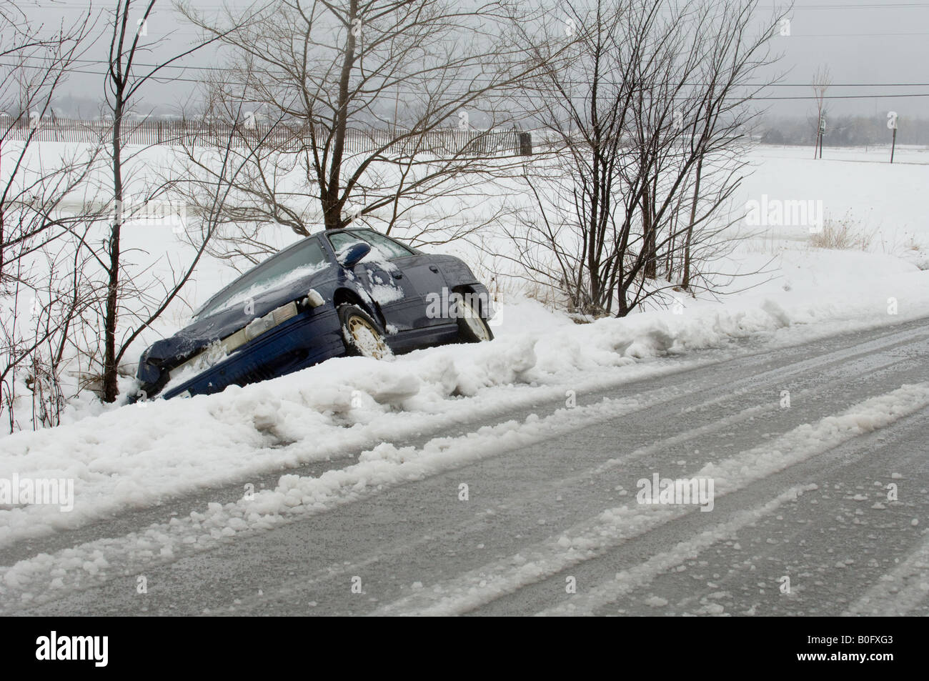 A car lies wreck in a ditch on a country road after a heavy snowstorm ...