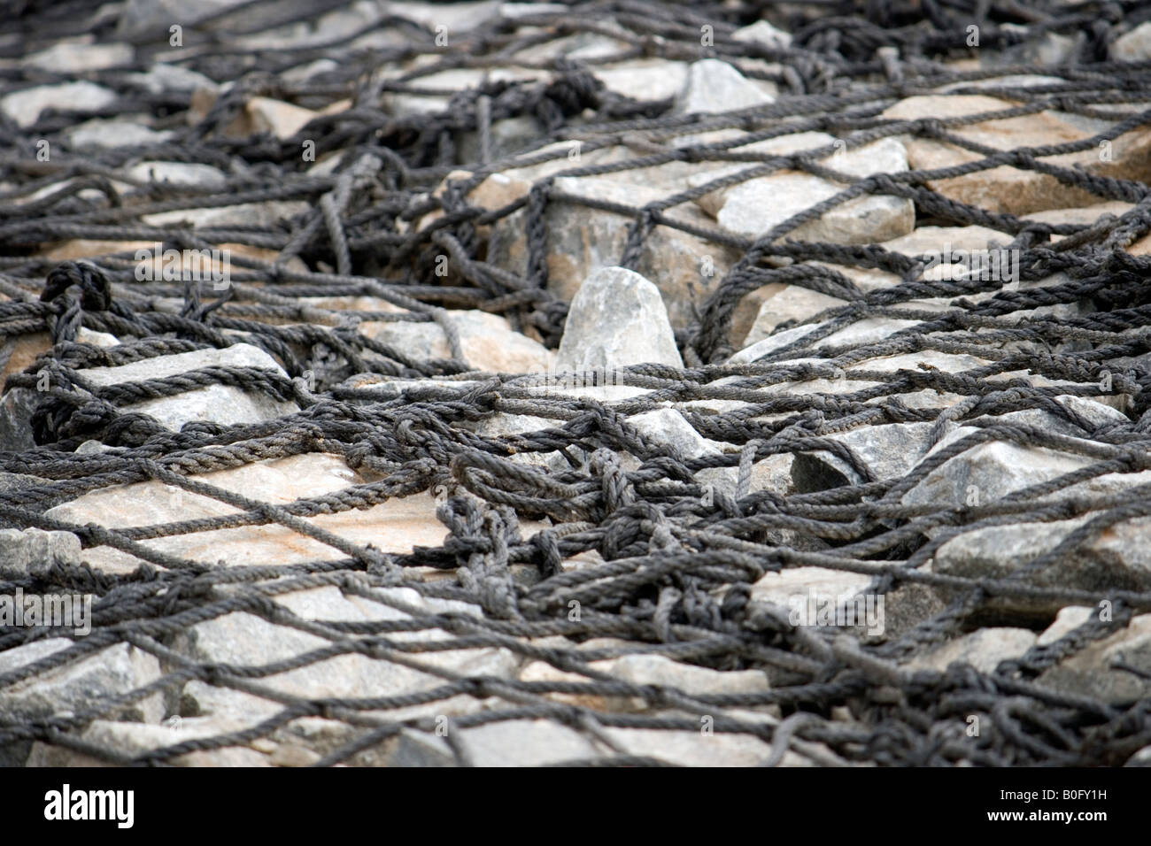 Rocks tied up with ropes Stock Photo - Alamy