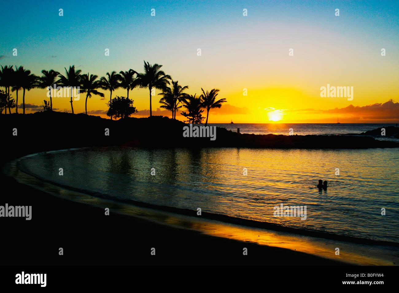 Romantic couple kissing in a lagoon on Oahu, Hawaii, during a beautiful ...