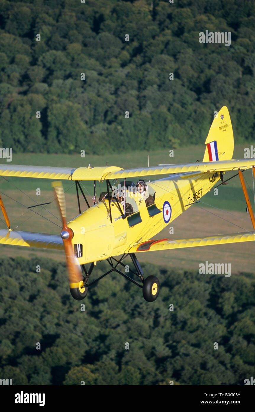 Old British trainer biplane De Havilland DH-82c Tiger Moth in flight ...