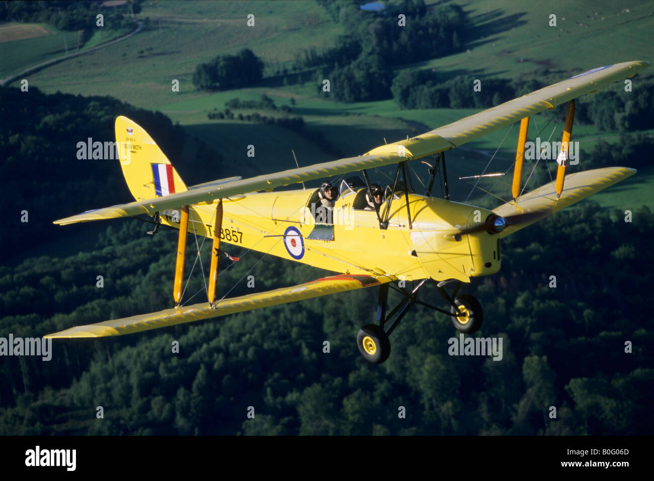 Old British trainer biplane De Havilland DH-82c Tiger Moth in flight ...