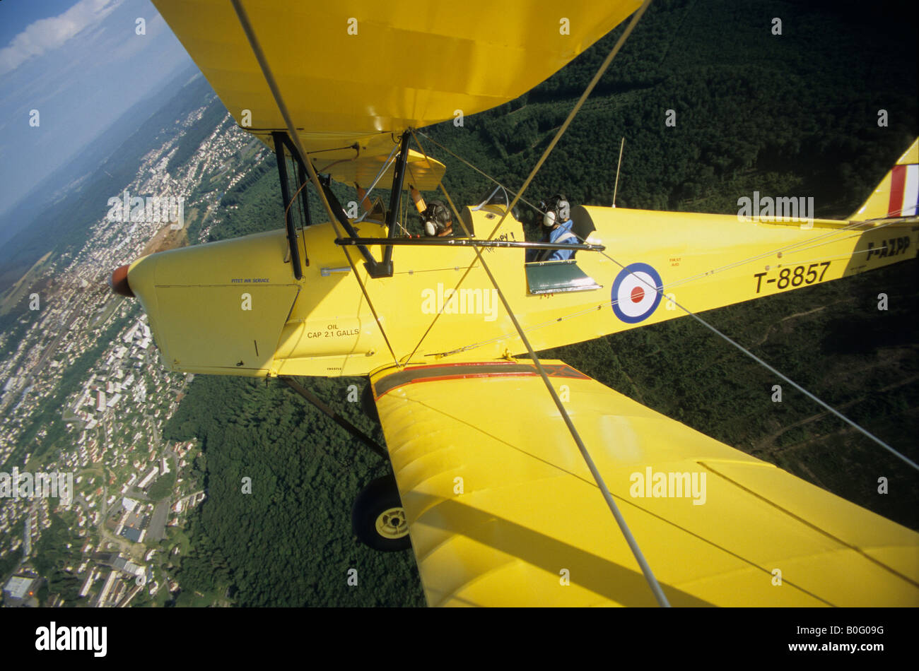 Old British trainer biplane De Havilland DH-82c Tiger Moth in flight ...