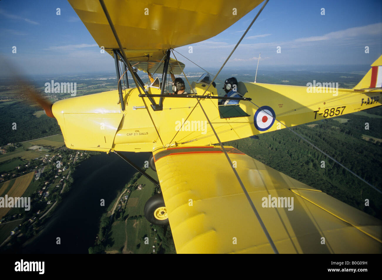 Old British trainer biplane De Havilland DH-82c Tiger Moth in flight ...