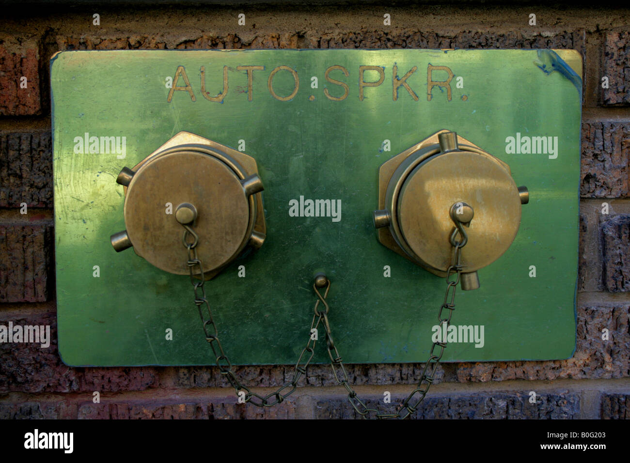 A fire hose plug on the side of a building Stock Photo - Alamy