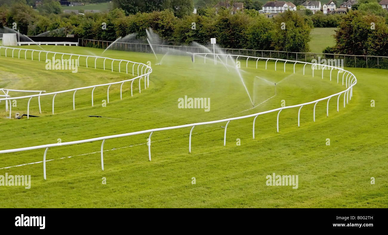 sprinklers watering racecourse Stock Photo - Alamy