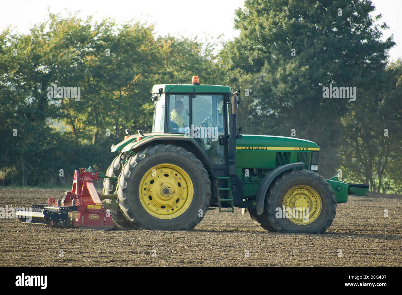John Deere tractor power harrowing a field, Suffolk Stock Photo ...