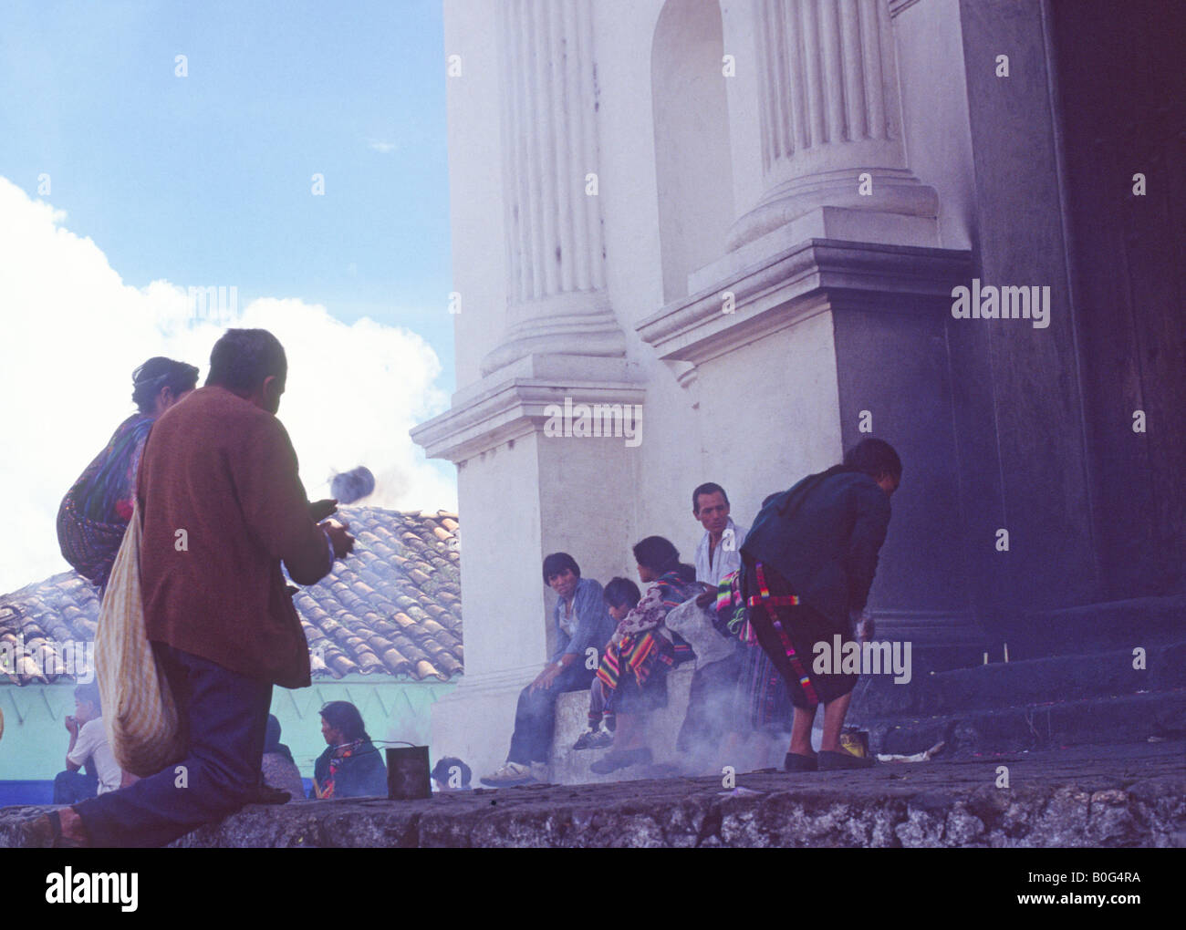 Incense burns and people praying outside santo tomas church hi-res ...