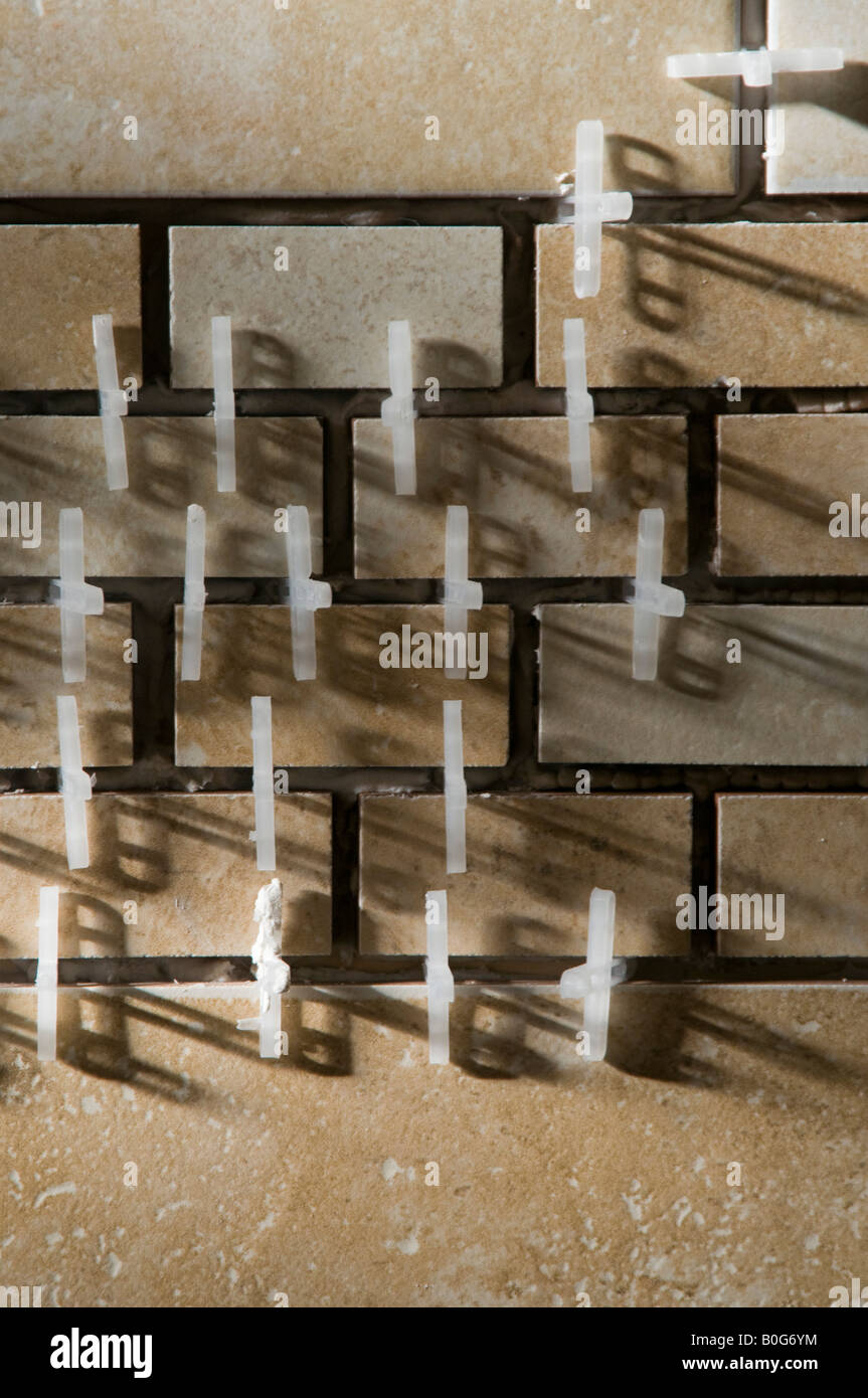 Tiling spacers inbetween mosaic tiles Stock Photo - Alamy