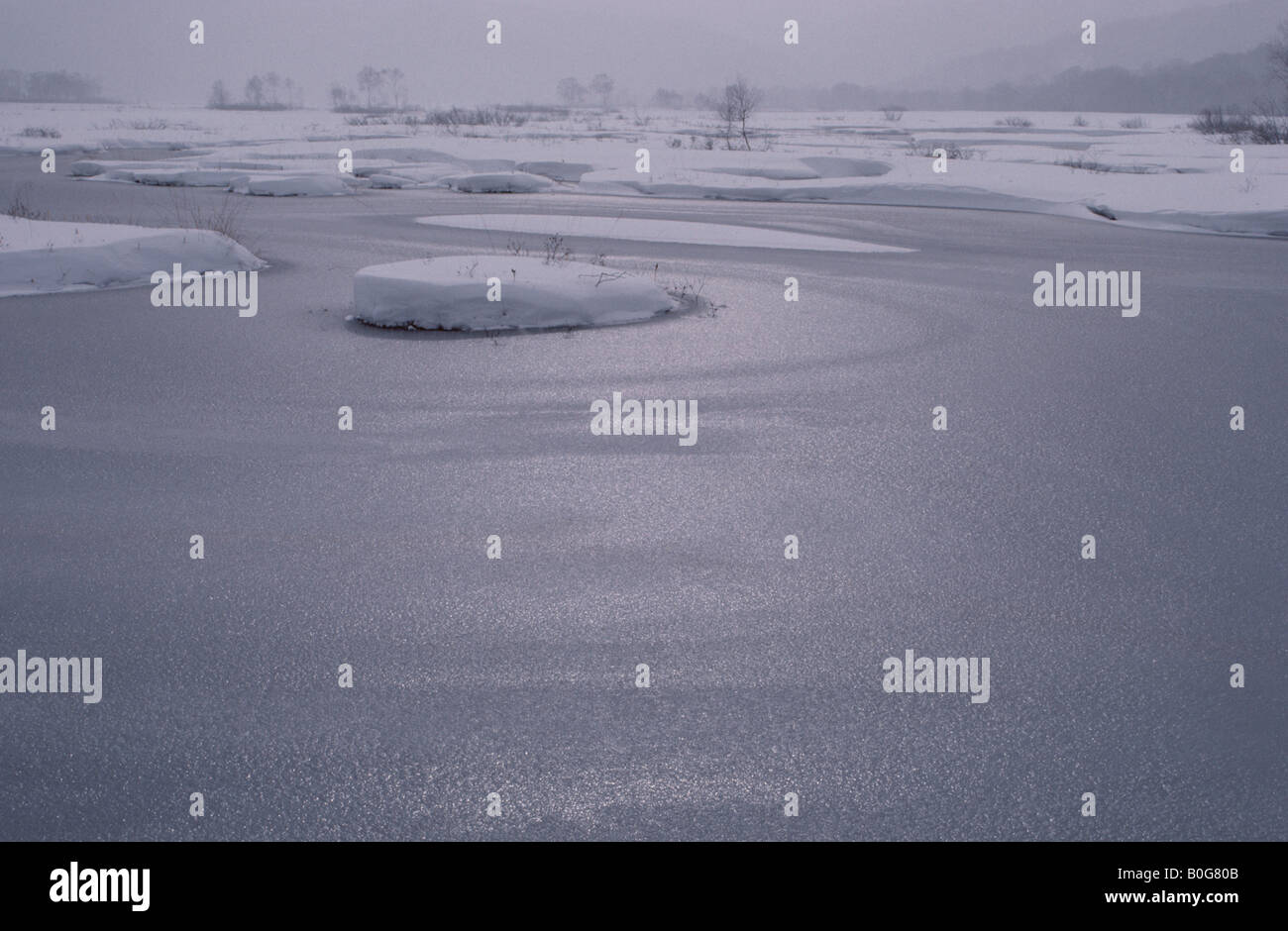 Frozen Pond With Snow Patches Stock Photo - Alamy