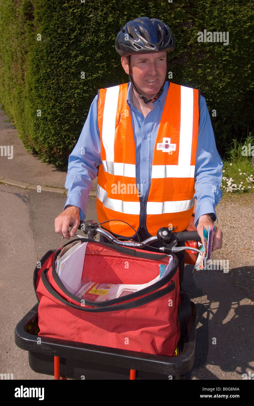 A Postman On His Round in the Uk in Spring Stock Photo - Alamy