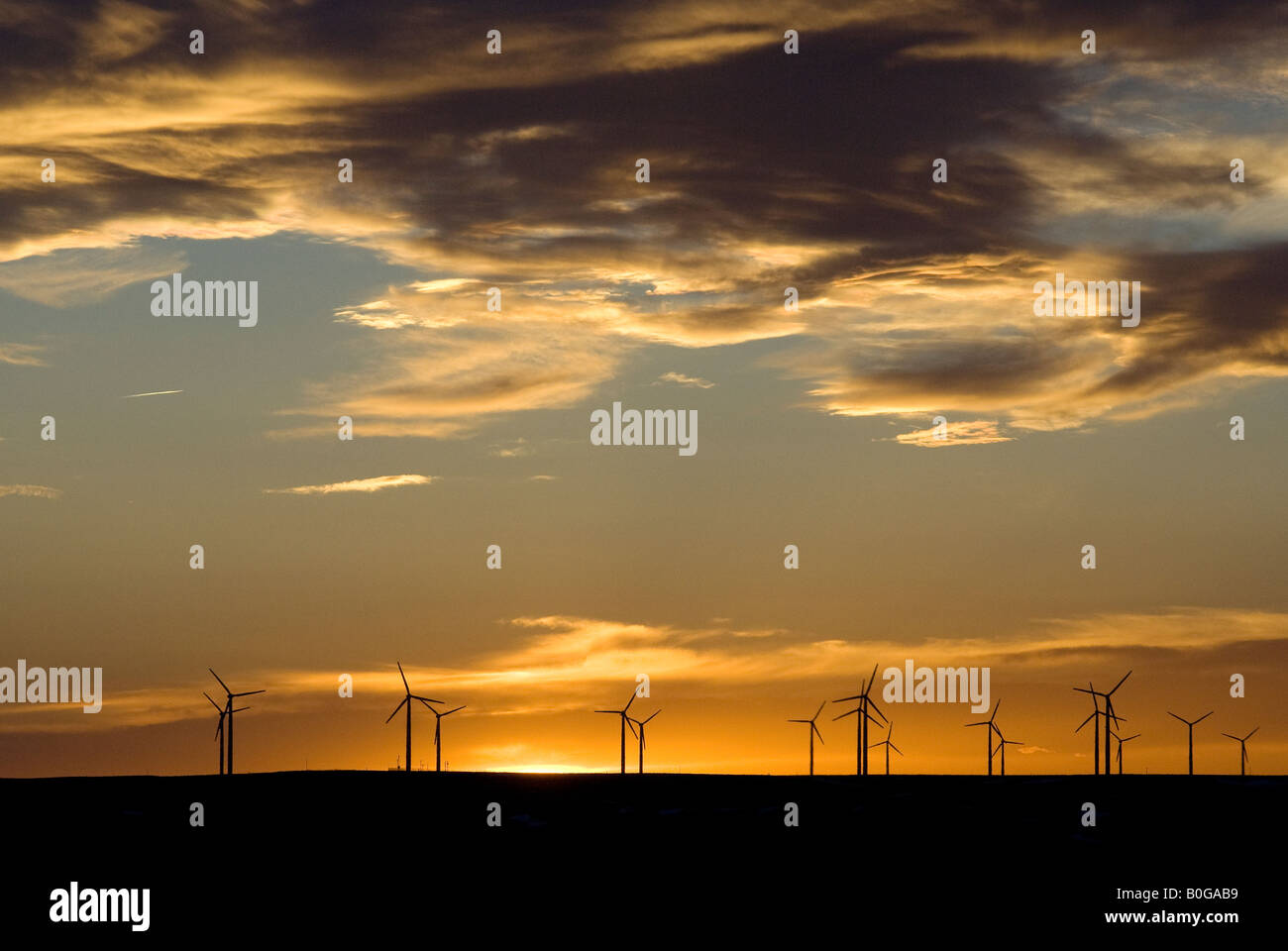 Modern wind turbines dot the horizon at sunset in eastern Colorado ...
