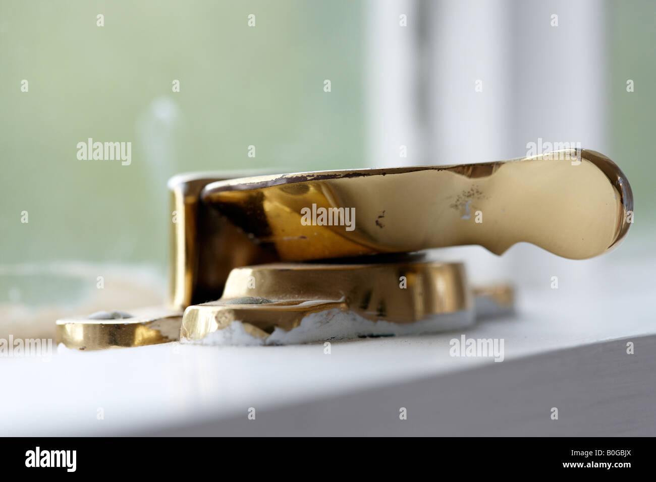 Brass plated, sash window lock Stock Photo - Alamy