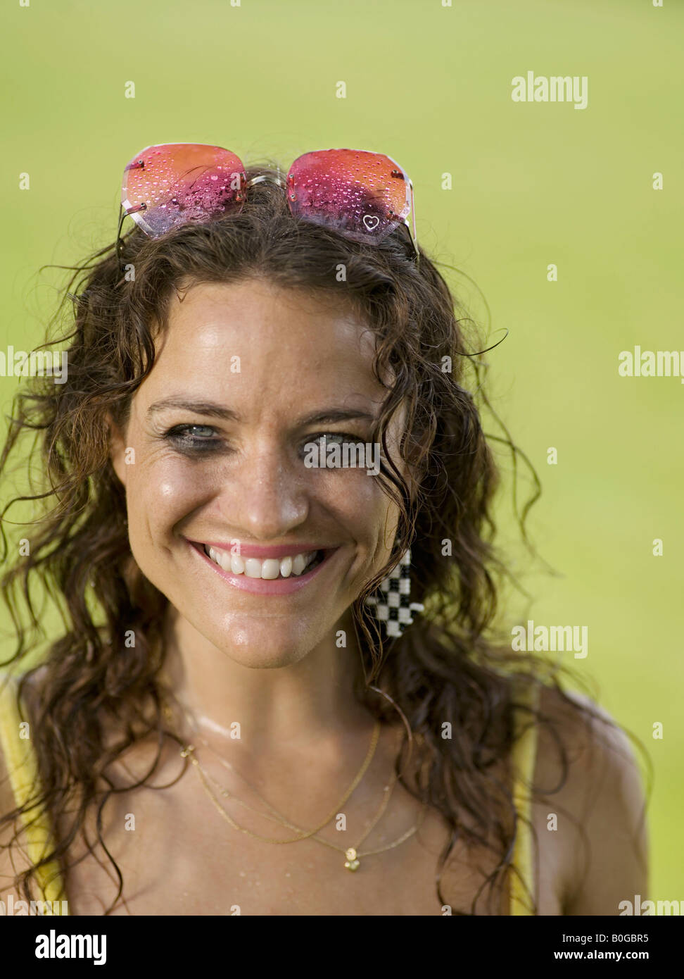 Woman looking and smiling into camera Stock Photo - Alamy