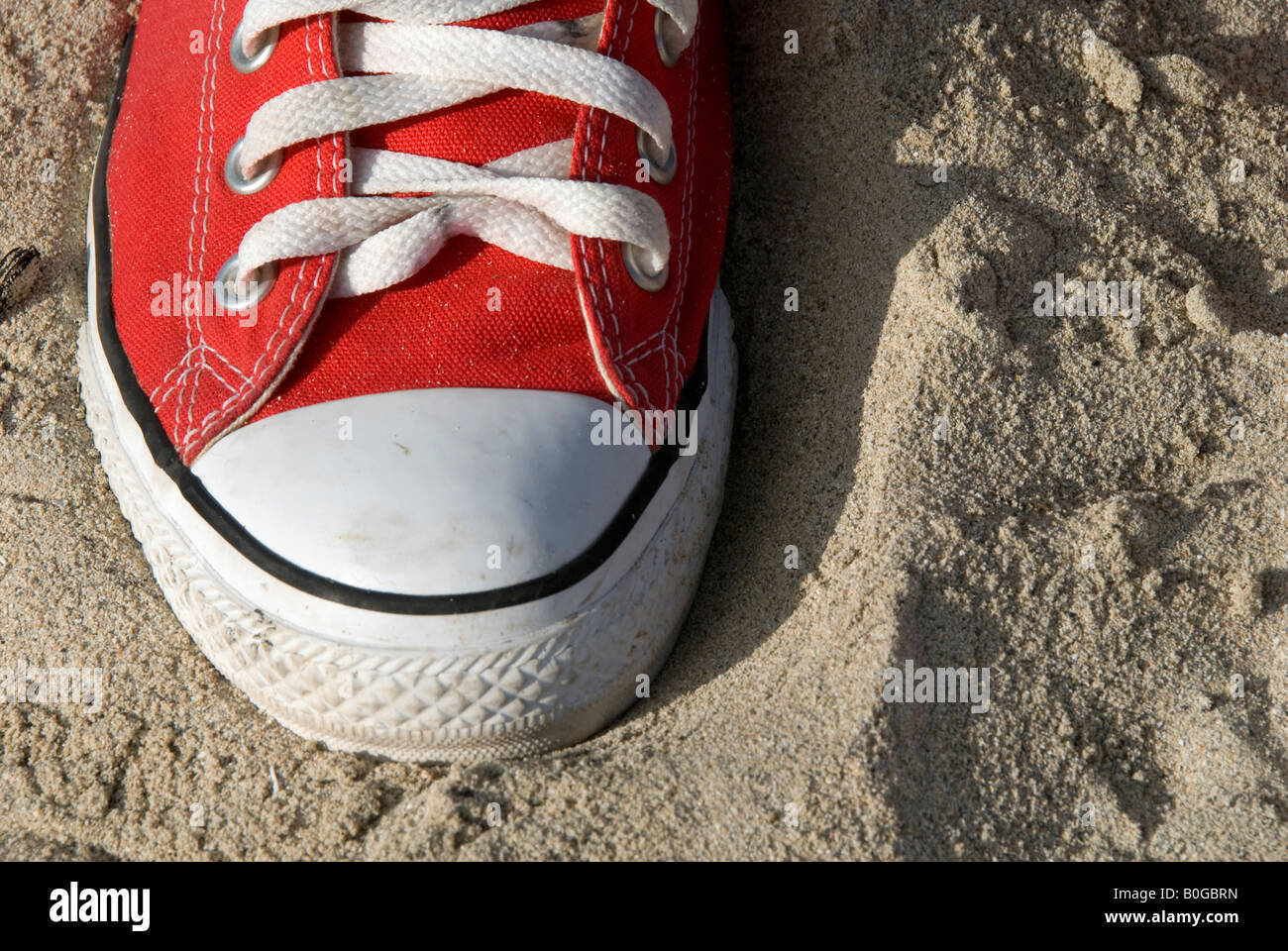 gym-shoe on the sand Stock Photo - Alamy