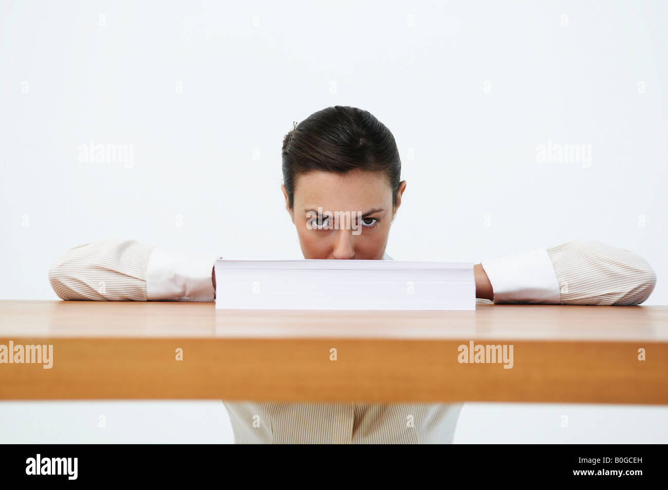 Young woman leaning over desk hi-res stock photography and images - Alamy