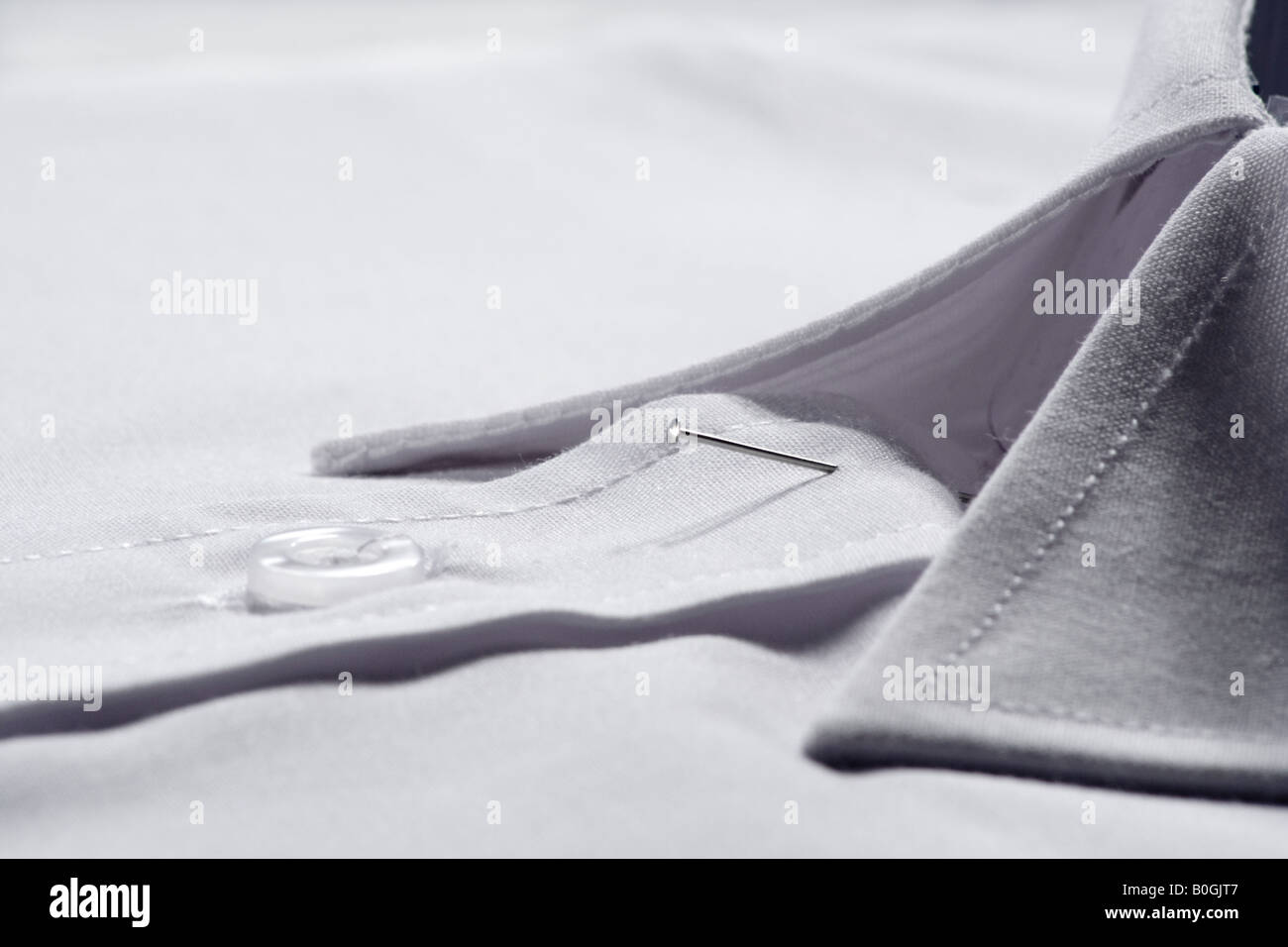 A pin in a brand new white shirt Stock Photo - Alamy