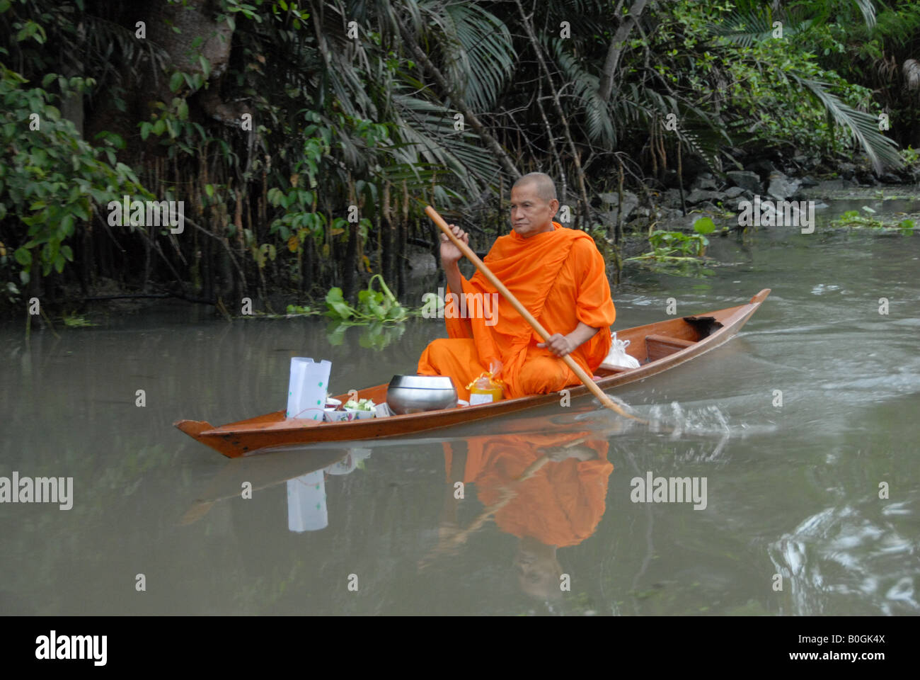 monk is rowing the boat to collect alms in the morning Stock Photo - Alamy