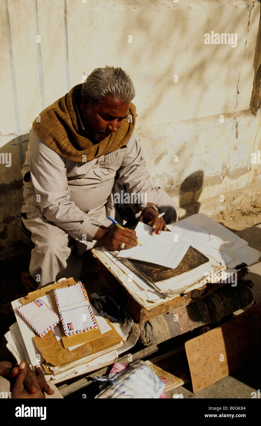 A man writing a letter on a desk outside, Quetta, Pakistan Stock Photo ...
