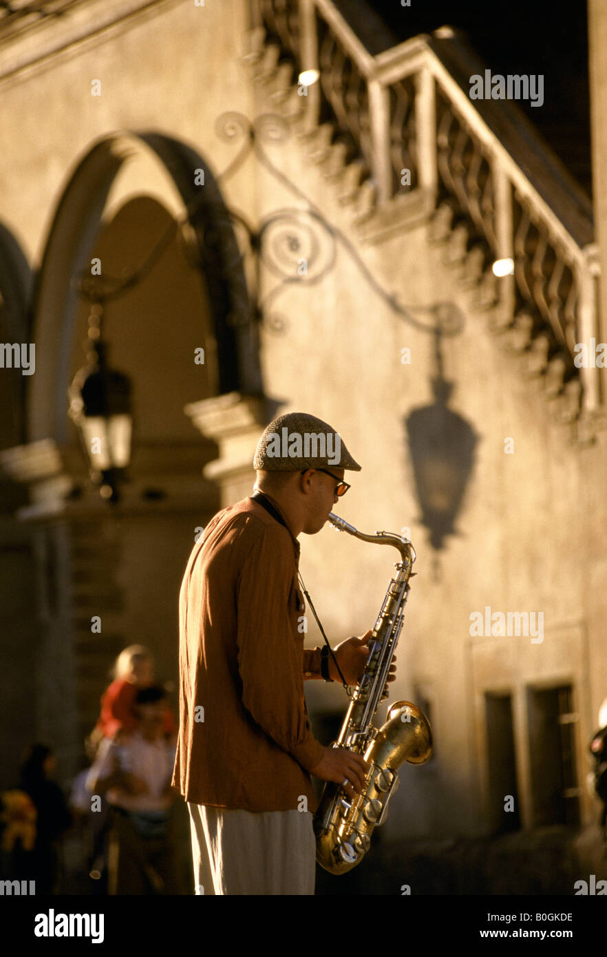 A saxophone player busking on Rynek Gl+¦wny (the Main Market Square ...