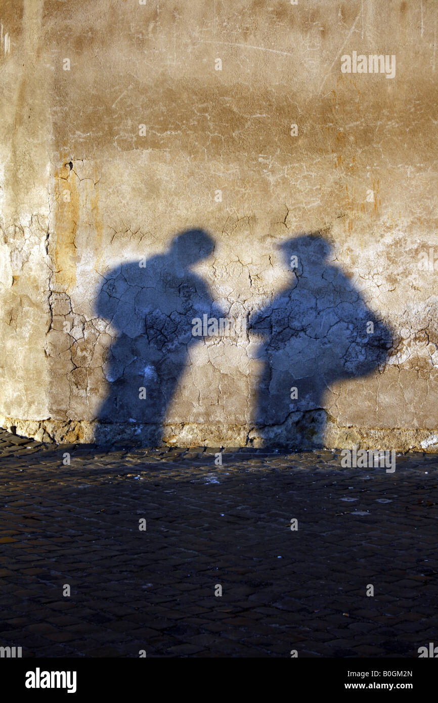 shadow of two people talking on wall in street road in city town Stock ...