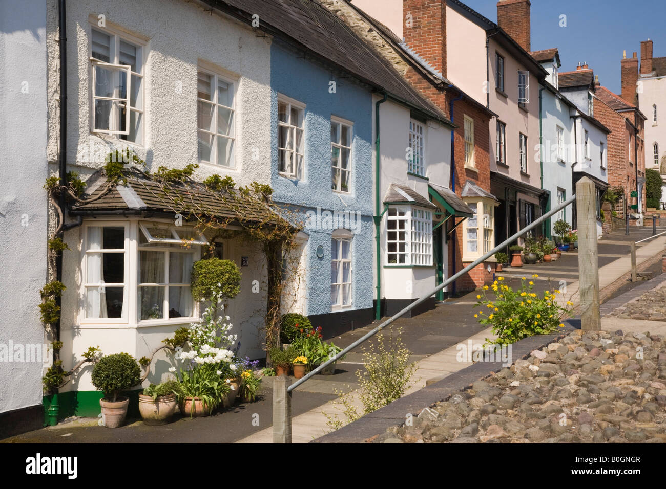 Row of picturesque colourful old terraced cottages town houses on a ...