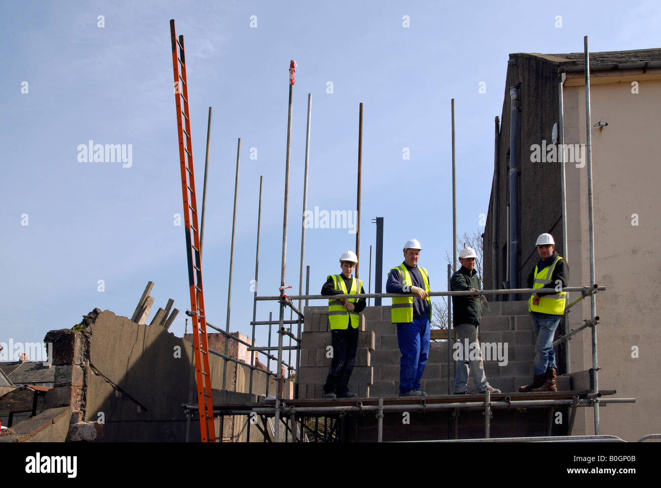 A group of builders posing for photographer on building site, UK Stock ...