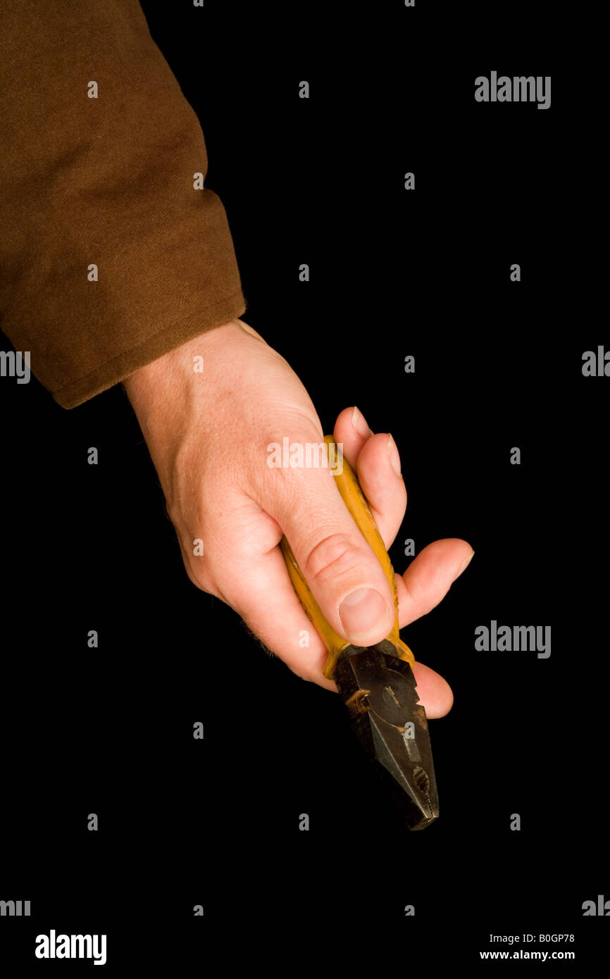 A man s hand holding old pliers Stock Photo - Alamy