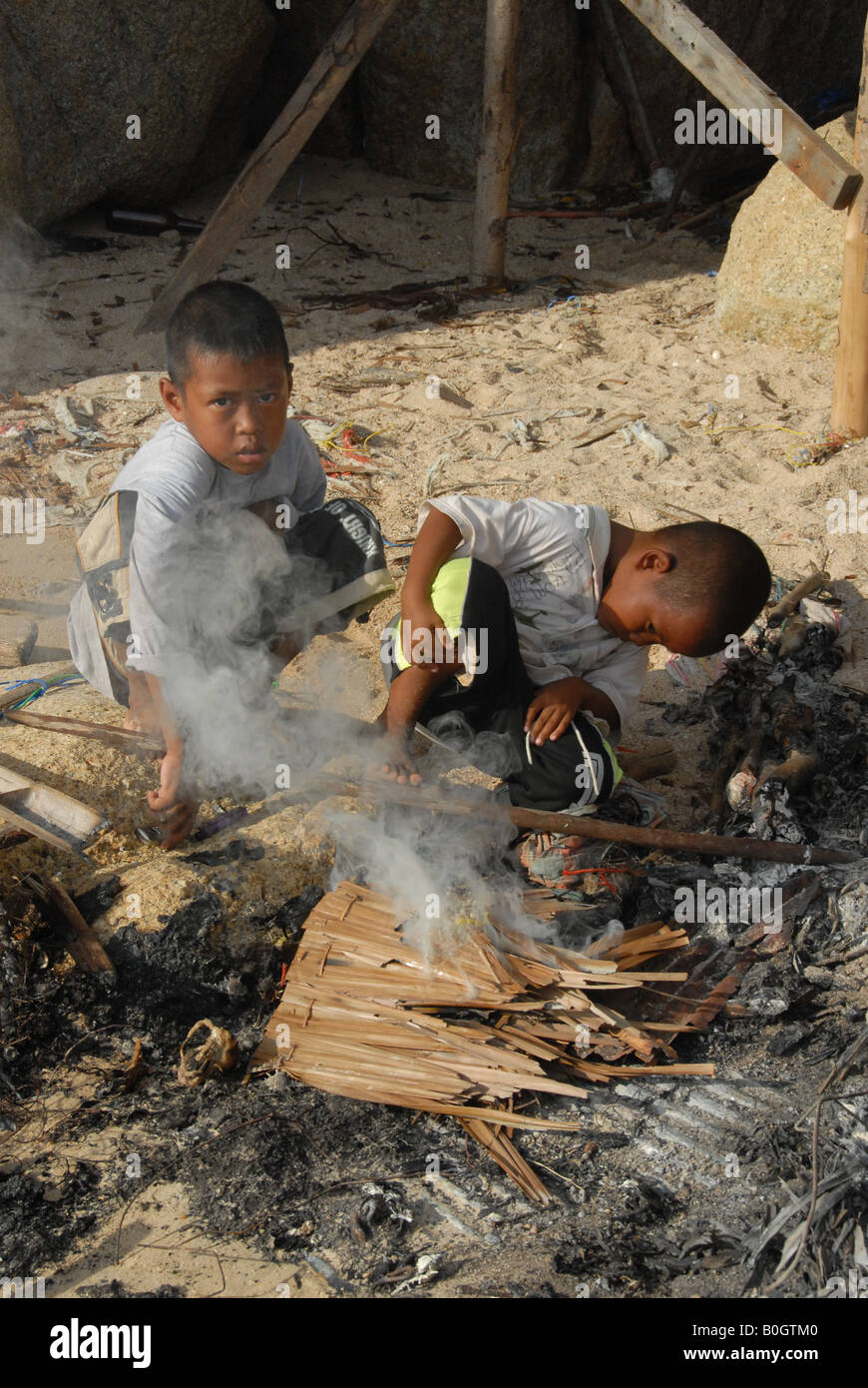 two little boys are burning fish at Koh samui, thailand Stock Photo - Alamy