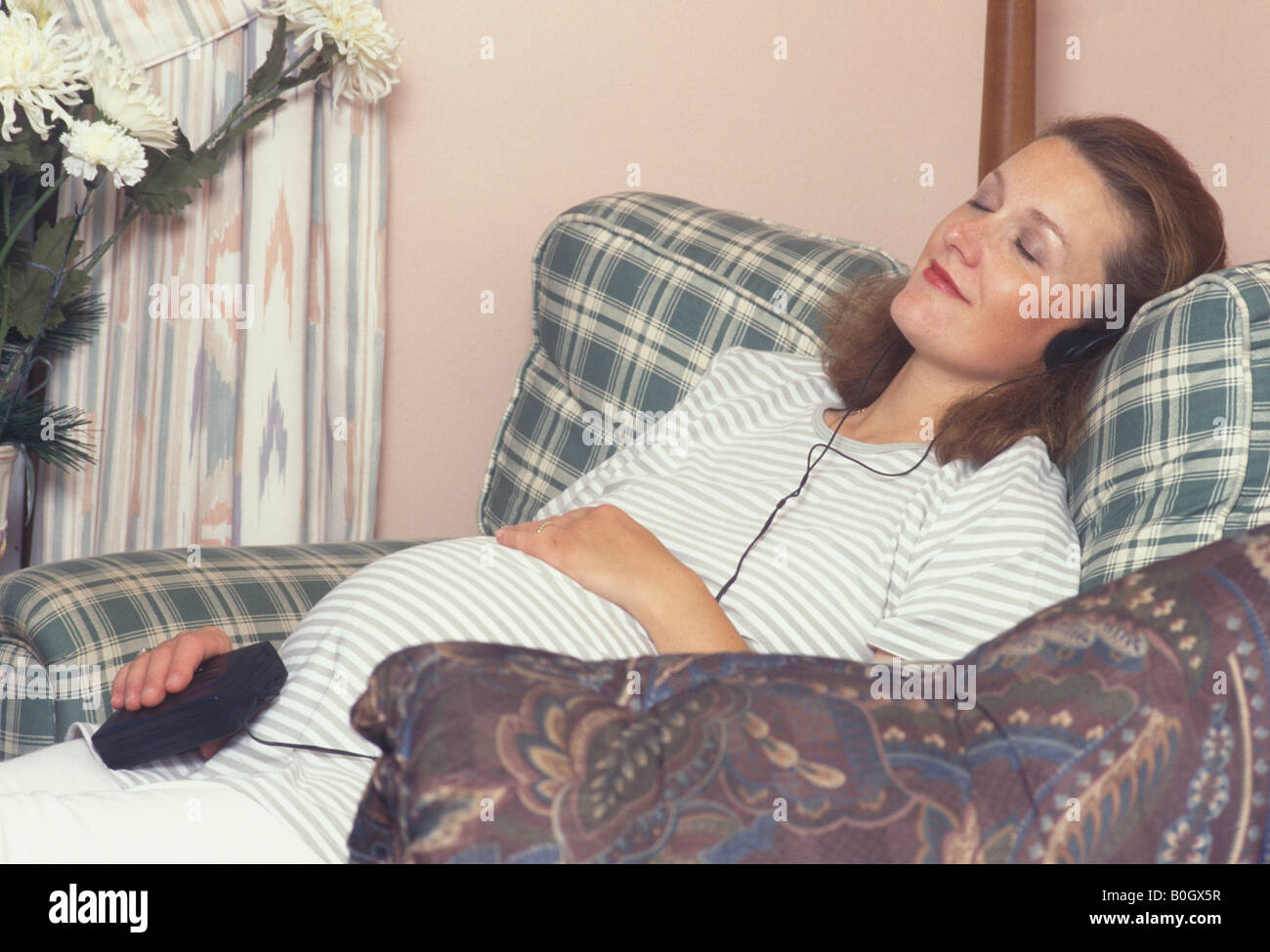 pregnant woman relaxing listening to music or relaxation tape Stock ...