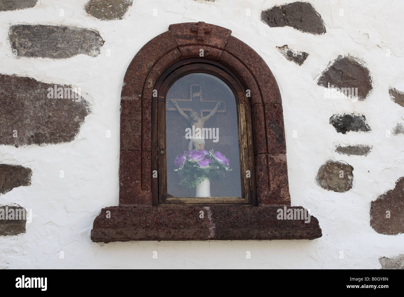 Crucifix on display in a glassed in alcove on the side of the church in ...