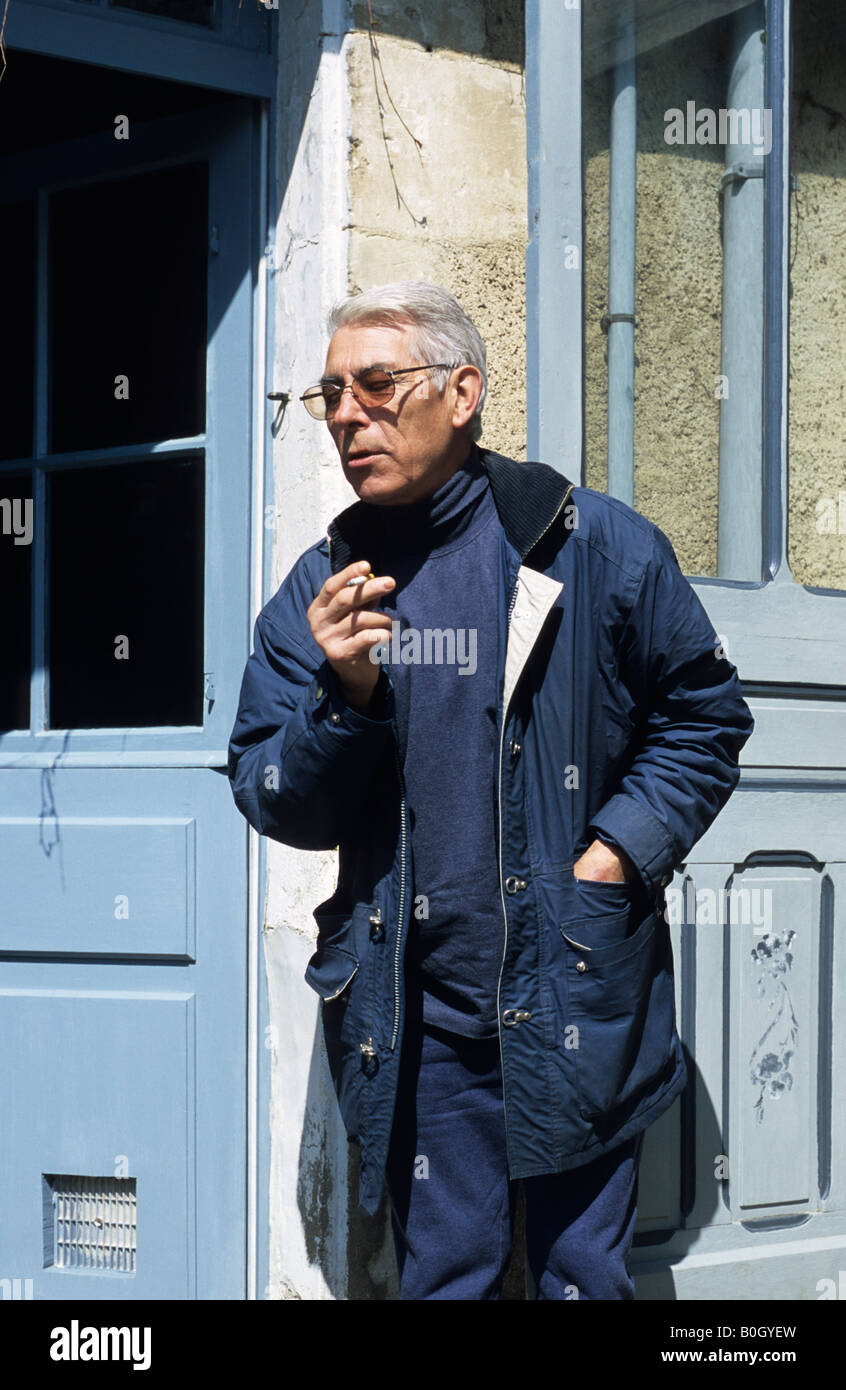 Male smoker enjoying cigarette outside public bar, France Stock Photo ...