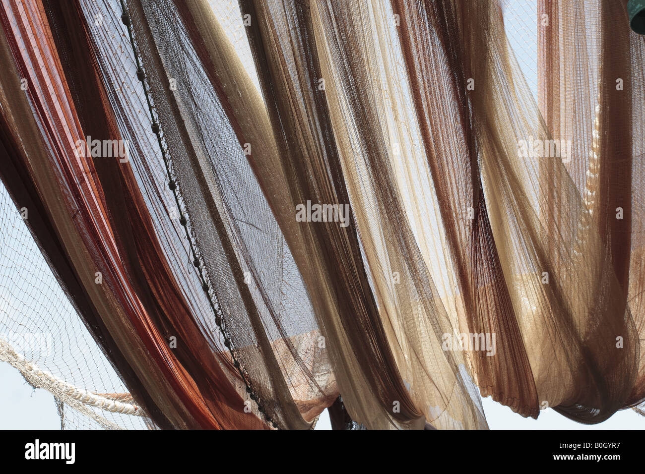 Old fishing nets draped over a beam to provide shade Stock Photo - Alamy