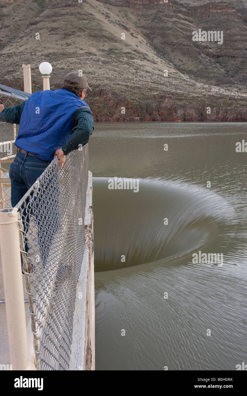 Man watches water disappear at the Owyhee Dam in South Eastern Oregon ...