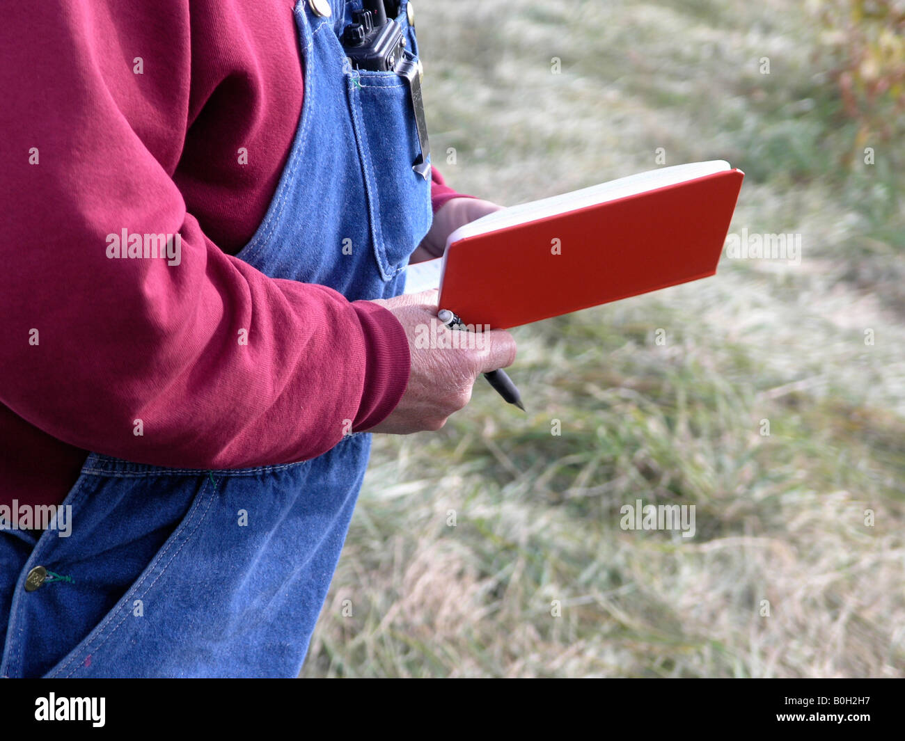 Workman filling out a log book Stock Photo - Alamy