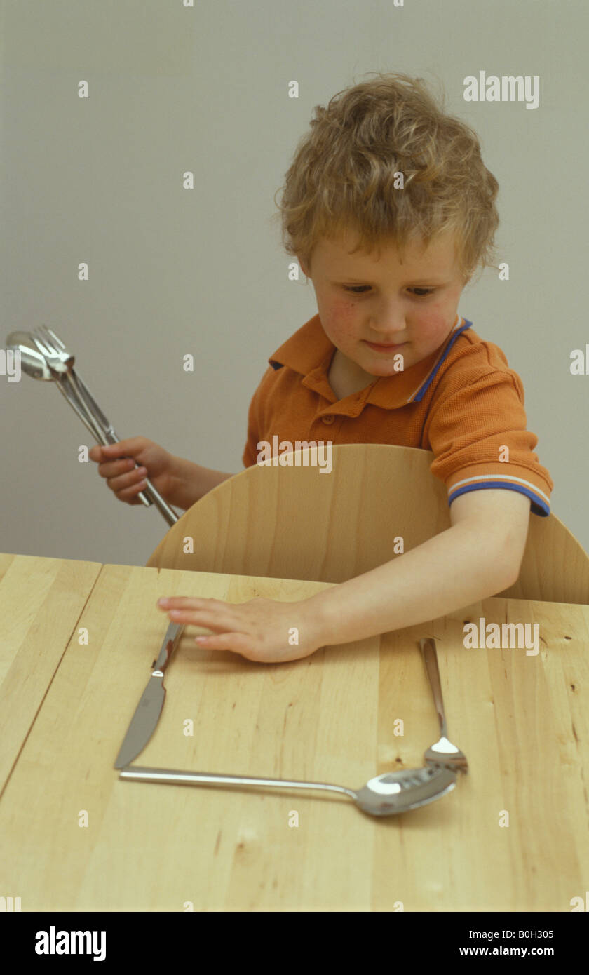 little boy setting the table Stock Photo - Alamy