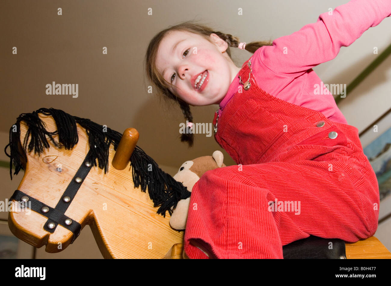 female child on wooden rocking horse girl Stock Photo - Alamy